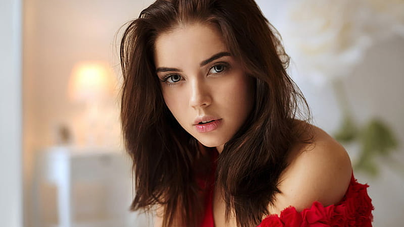 Closeup View Of Beautiful Girl Model Is Sitting In Blur Background