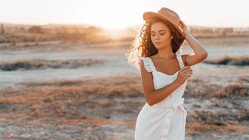 Curly Hair Girl Model Is Wearing White Dress And Brown Hat In Blur